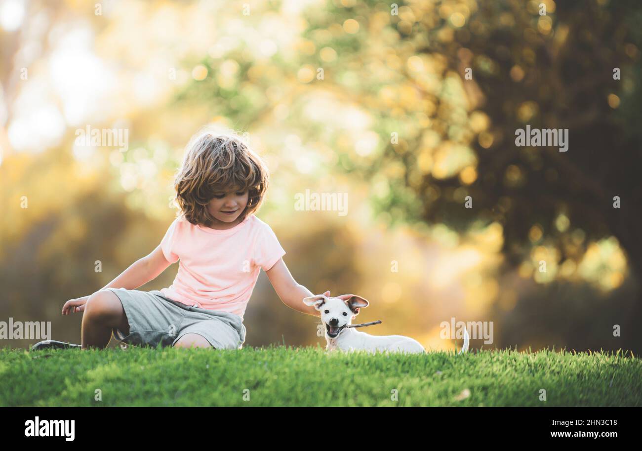 Kid with puppy dog. Portrait child boy with pet Stock Photo - Alamy