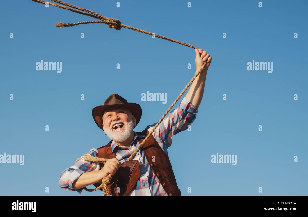 Old wild west cowboy with lasso rope. Bearded western man with brown ...