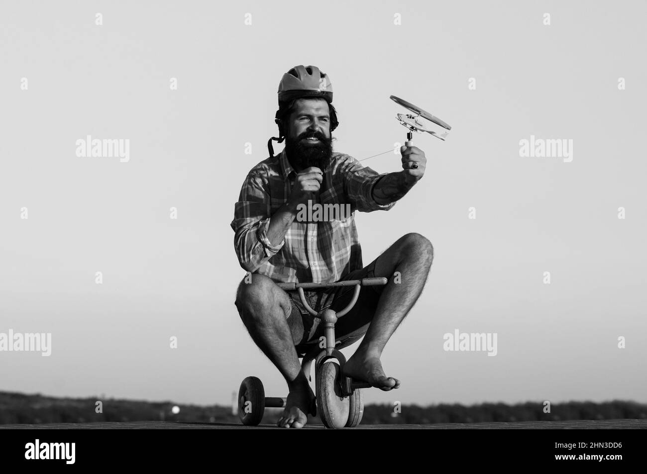 Childhood memory. Crazy Young man riding three wheeled bicycle Stock ...