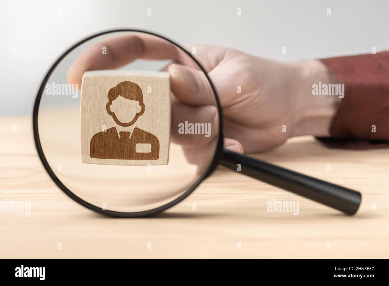 Searching for new team member. Male employer holding magnifier in hand ...