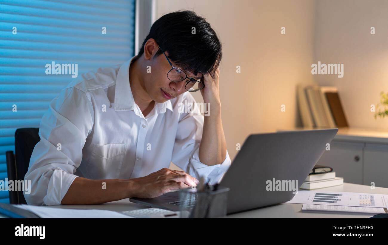 Overwork Concept The male officer resting his forehead on his right ...