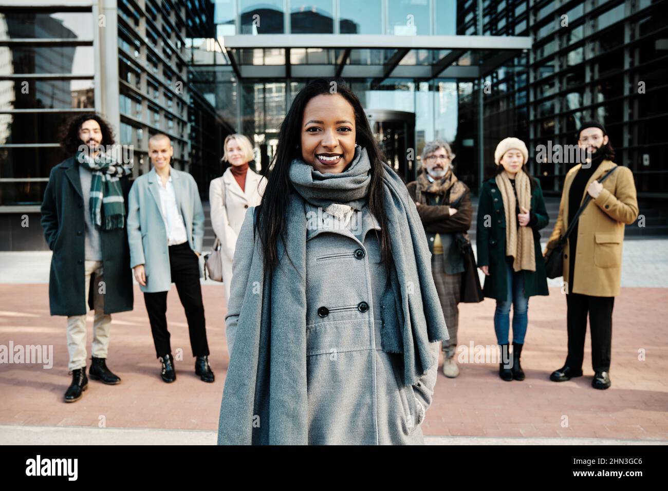 Leading businesswoman standing out from a group of business people ...