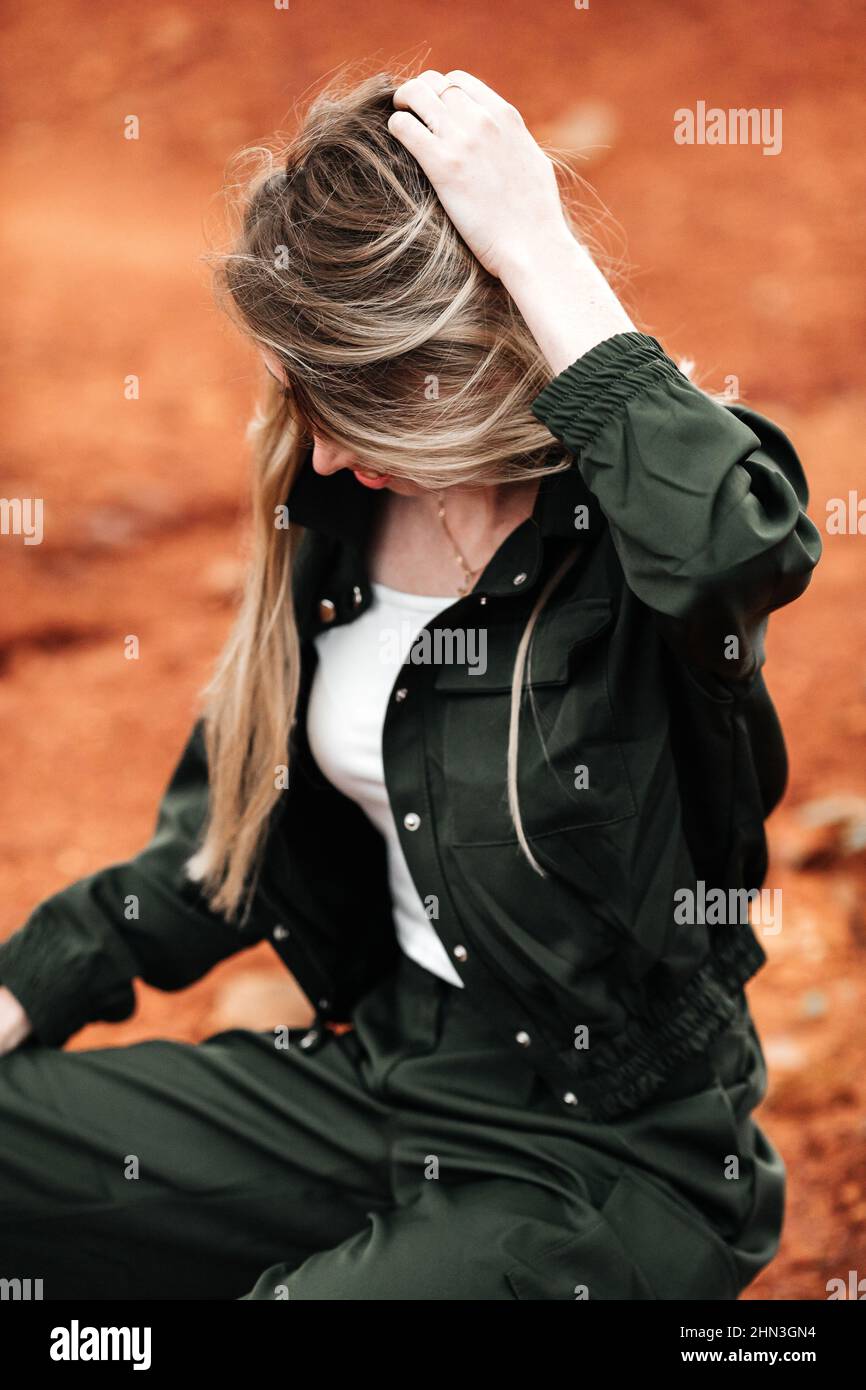 Girls in a post-apocalyptic place, a quarry with red earth and stones ...