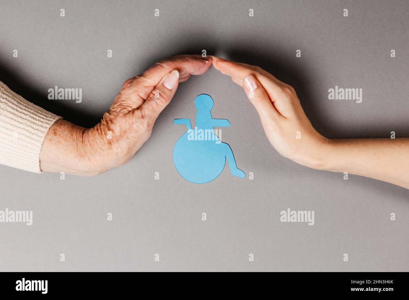 An elderly and a young woman folded their hands, protecting the ...