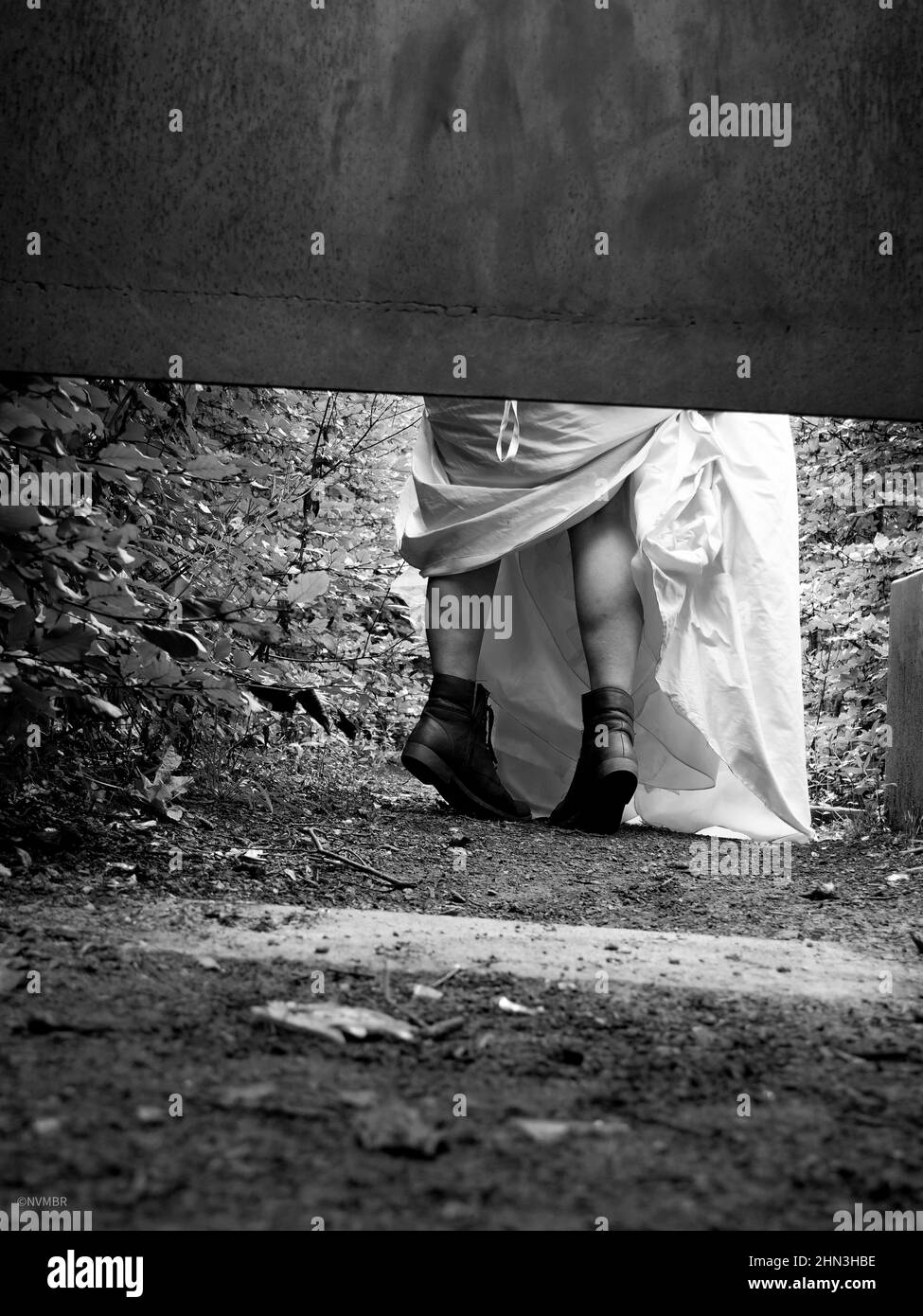 Vertical shot of a female's legs wearing a dress in grayscale Stock ...