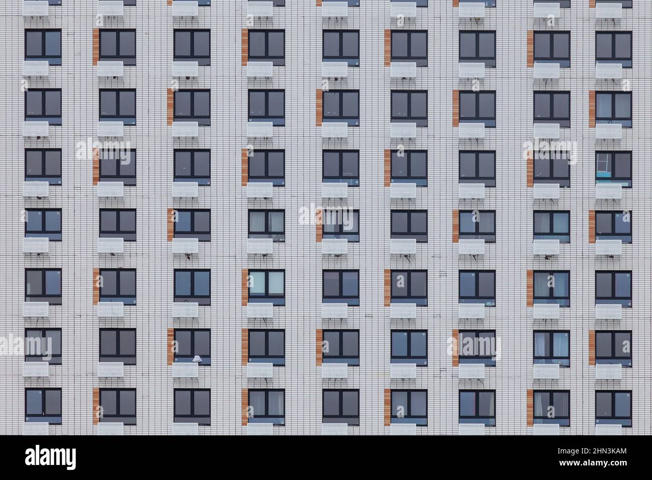 Fragment of the wall of a multi-storey white building with windows ...