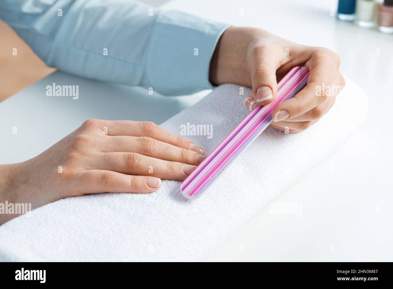 Woman using nail file and create nails shape Stock Photo - Alamy