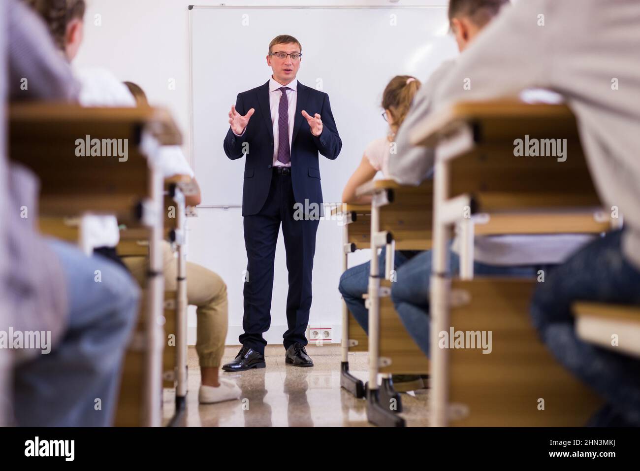 Friendly male teacher explaining lesson hi-res stock photography and ...