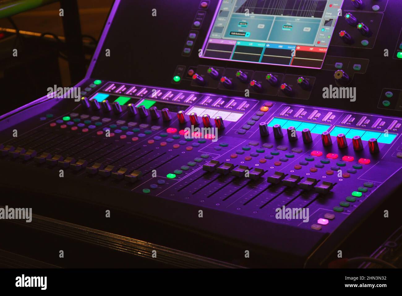 Modern digital mixing console with faders, control buttons and touch ...