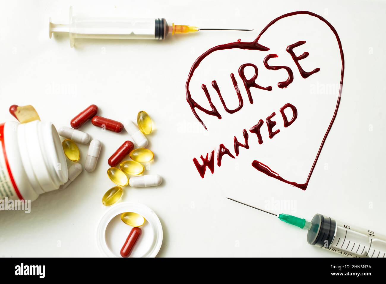 Nurse wanted written with blood next to syringes and pills, on white ...
