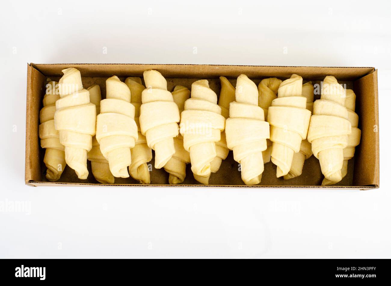 Frozen raw croissants in box on white background. Studio Photo Stock ...