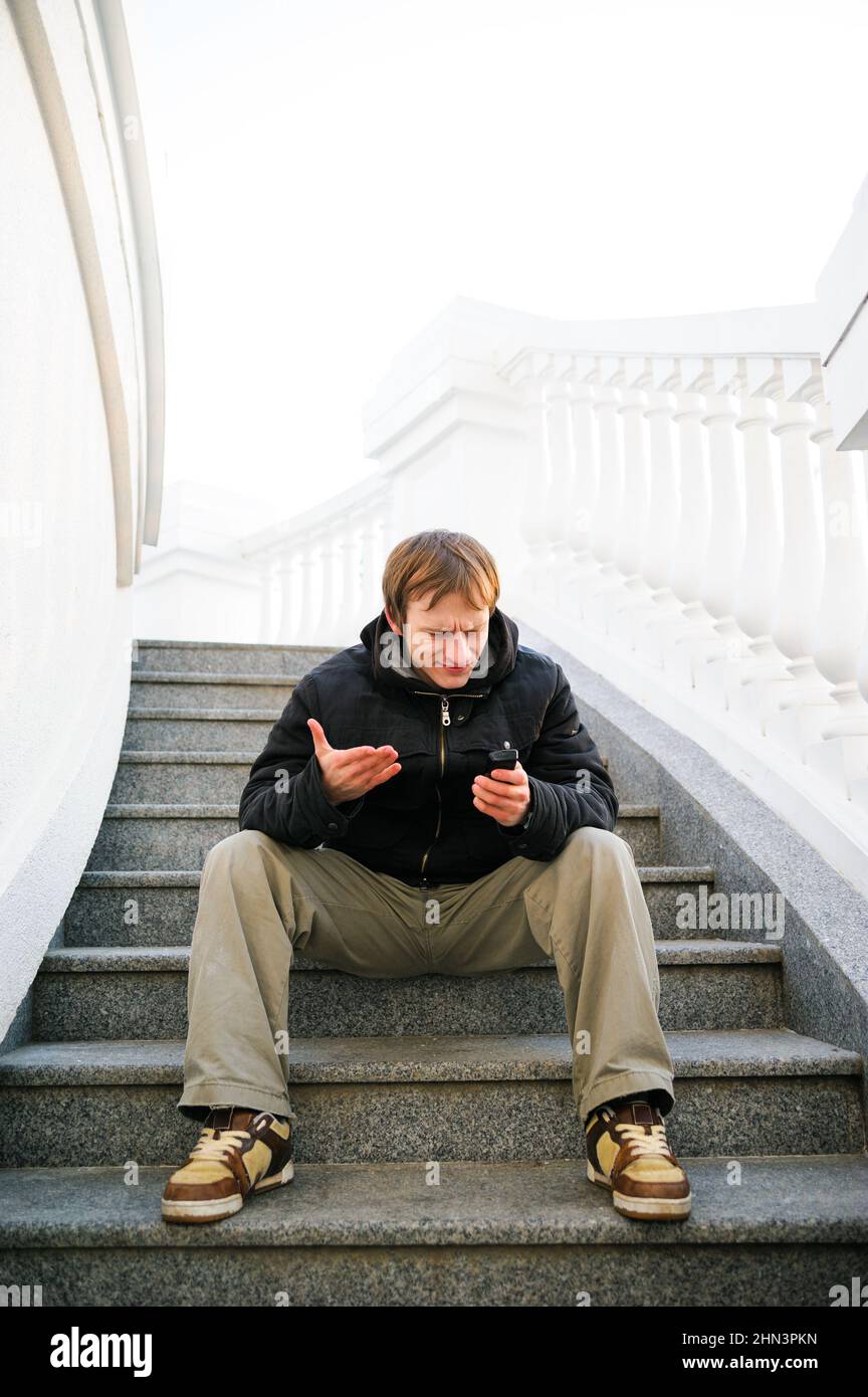 displeased man with phone. Bad connection Stock Photo - Alamy