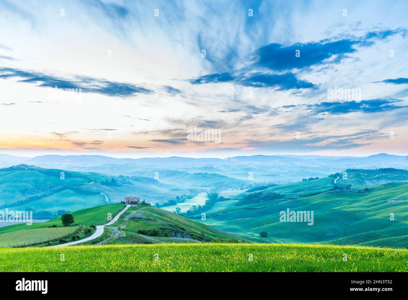 Dirt road to a farm on a hill in the dawn light Stock Photo - Alamy