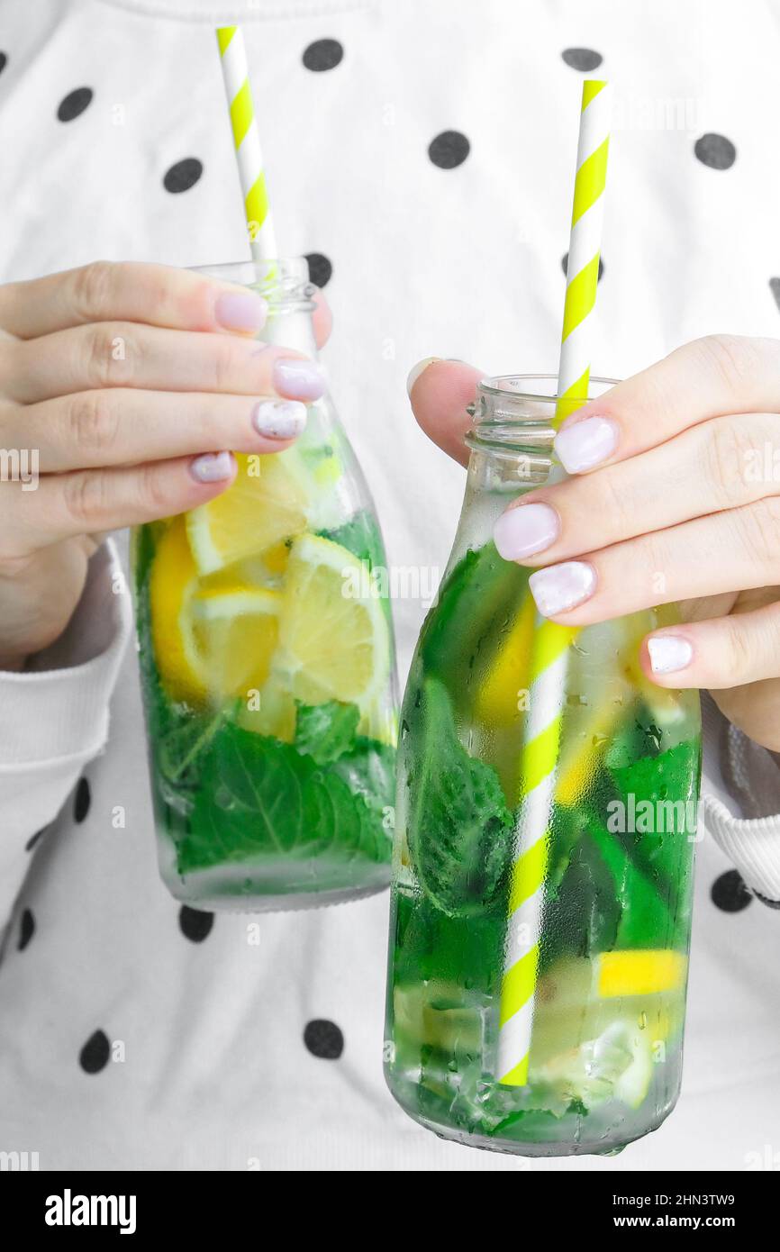 Female hand holding Mojito refreshing cocktail with eco paper drinking ...