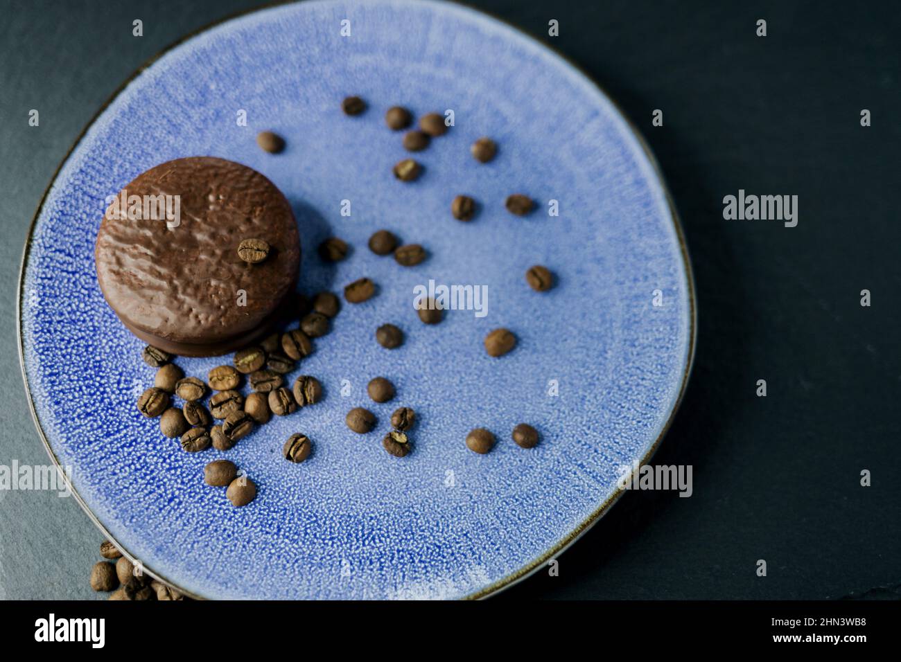 Choco pie sweet dessert on blue plate. Coffee beans and cake Stock ...