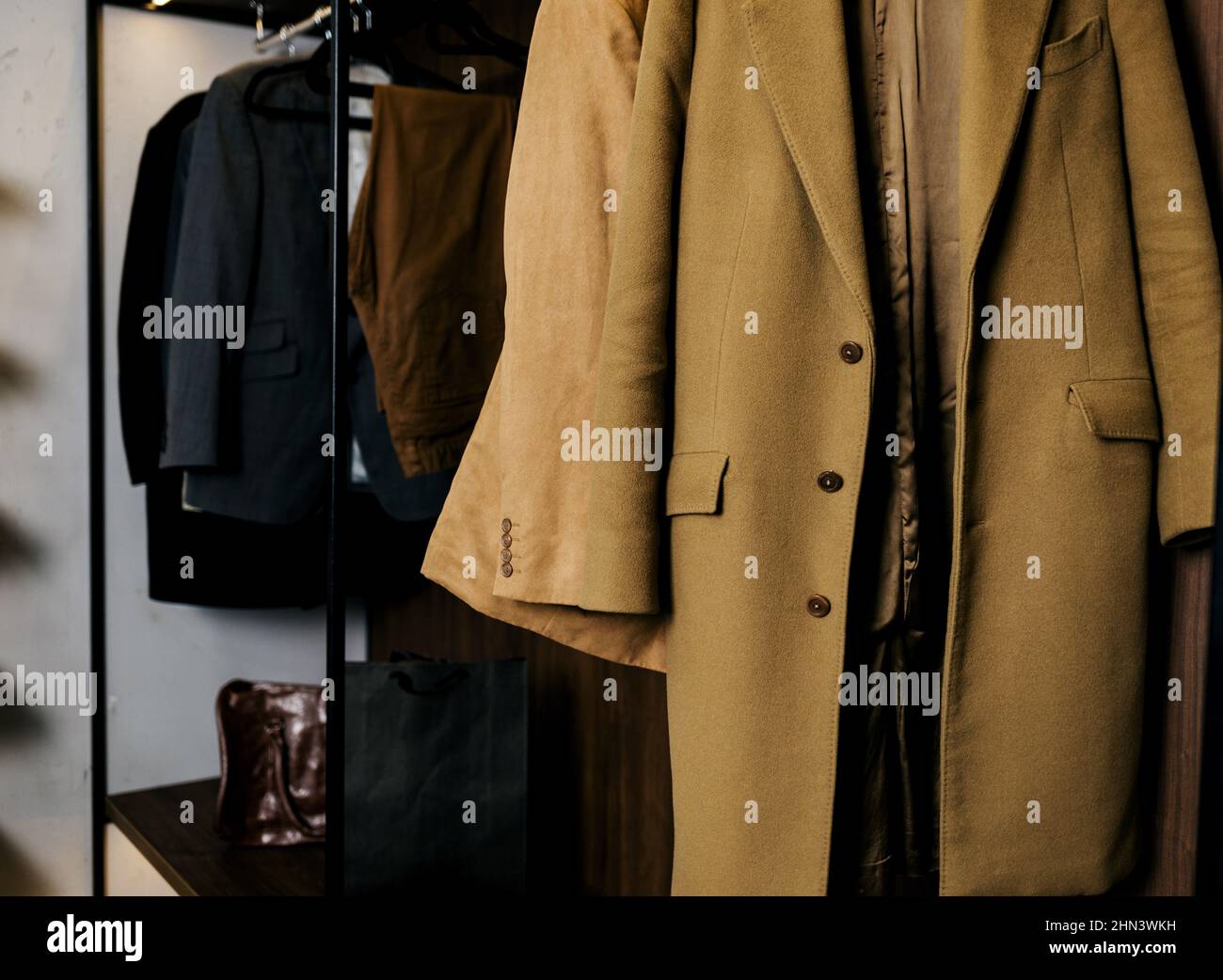 Row of fashion clothes of different colors clothing on hangers. Retail ...