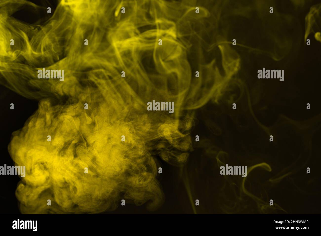 Yellow steam on a black background. Copy space Stock Photo - Alamy