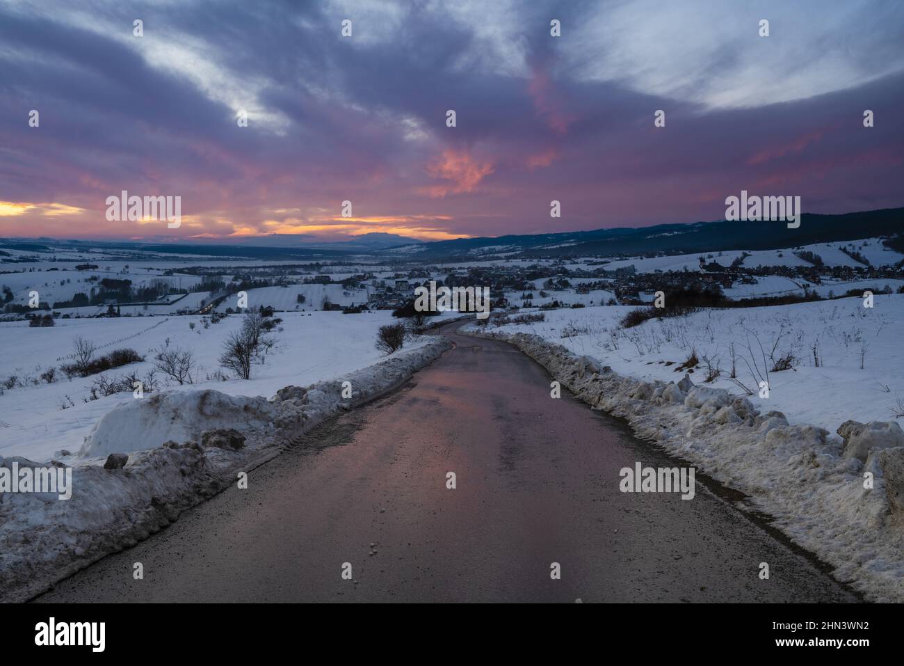 mountain road in snowy winter during a magnificent sunset Stock Photo ...