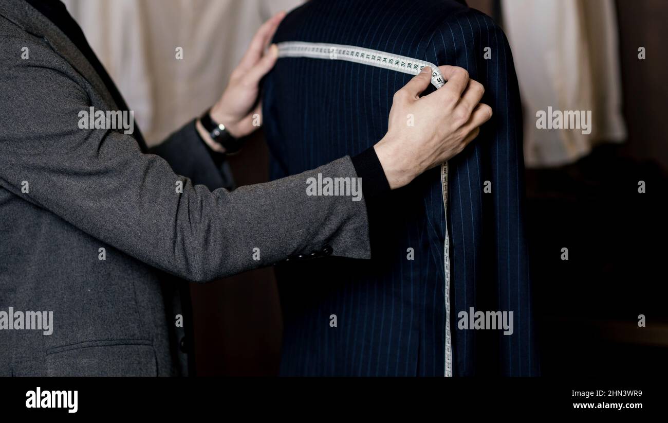 Tailor measuring business man for suit. self-employed. manufacturing ...