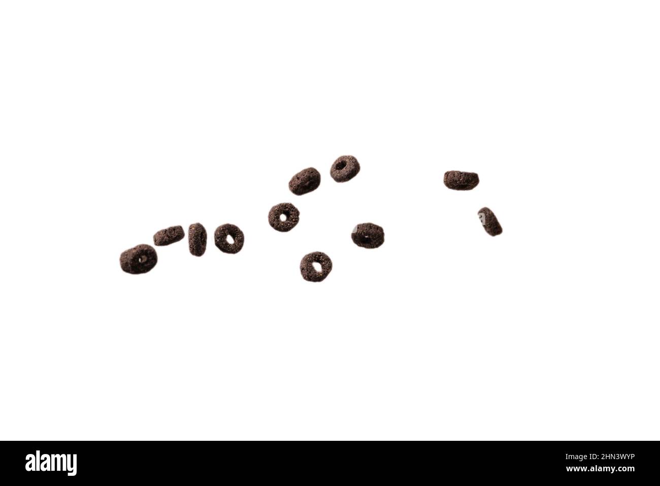 Chocolate rings cereal spill out into a bowl. Breakfast. Isolated on a ...