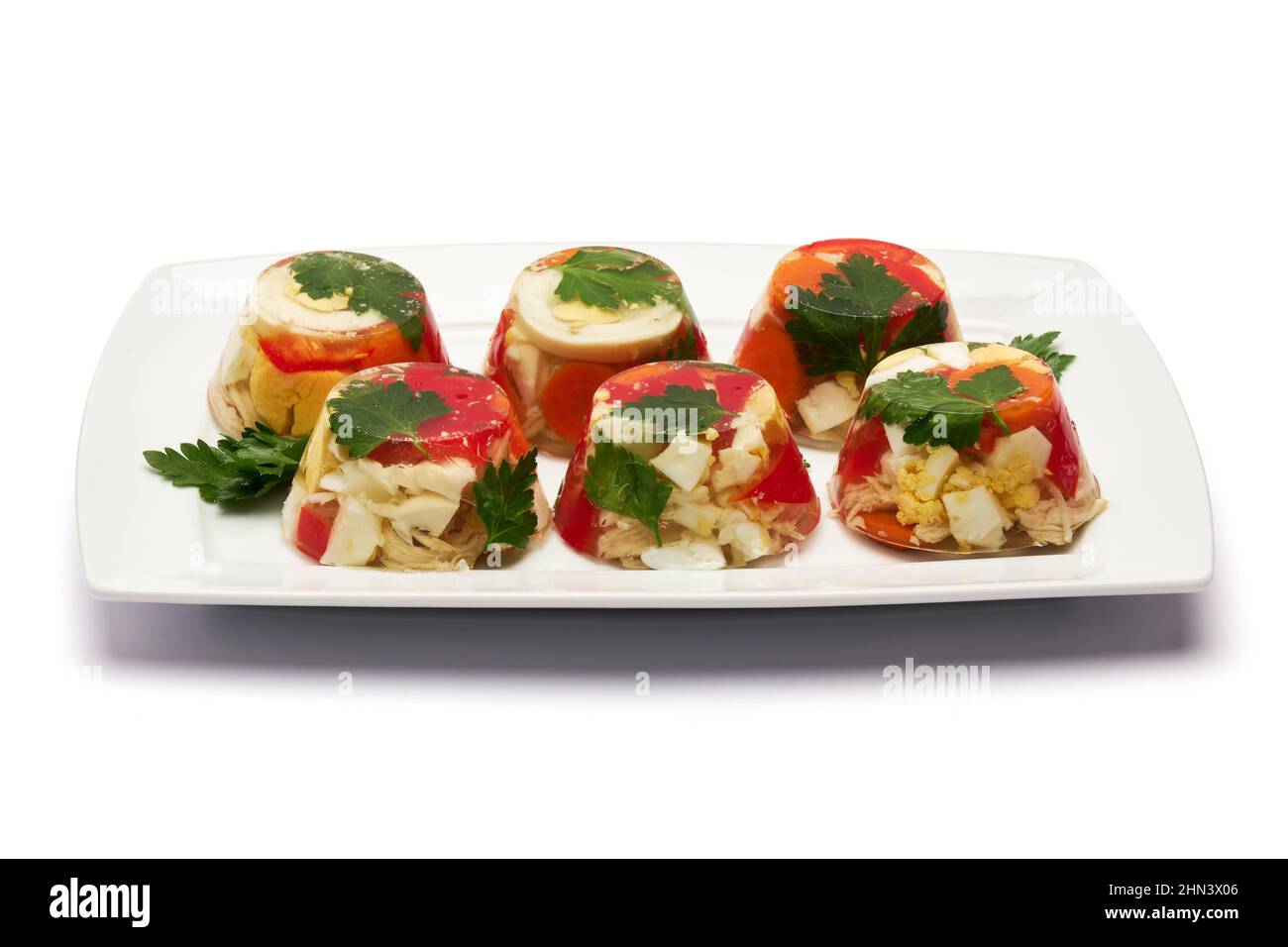 Portion of delicious chicken aspic on a plate isolated on white ...