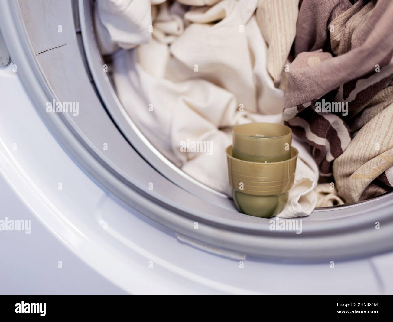 measuring cap for washing clothes. laundry room at home. Open washing ...