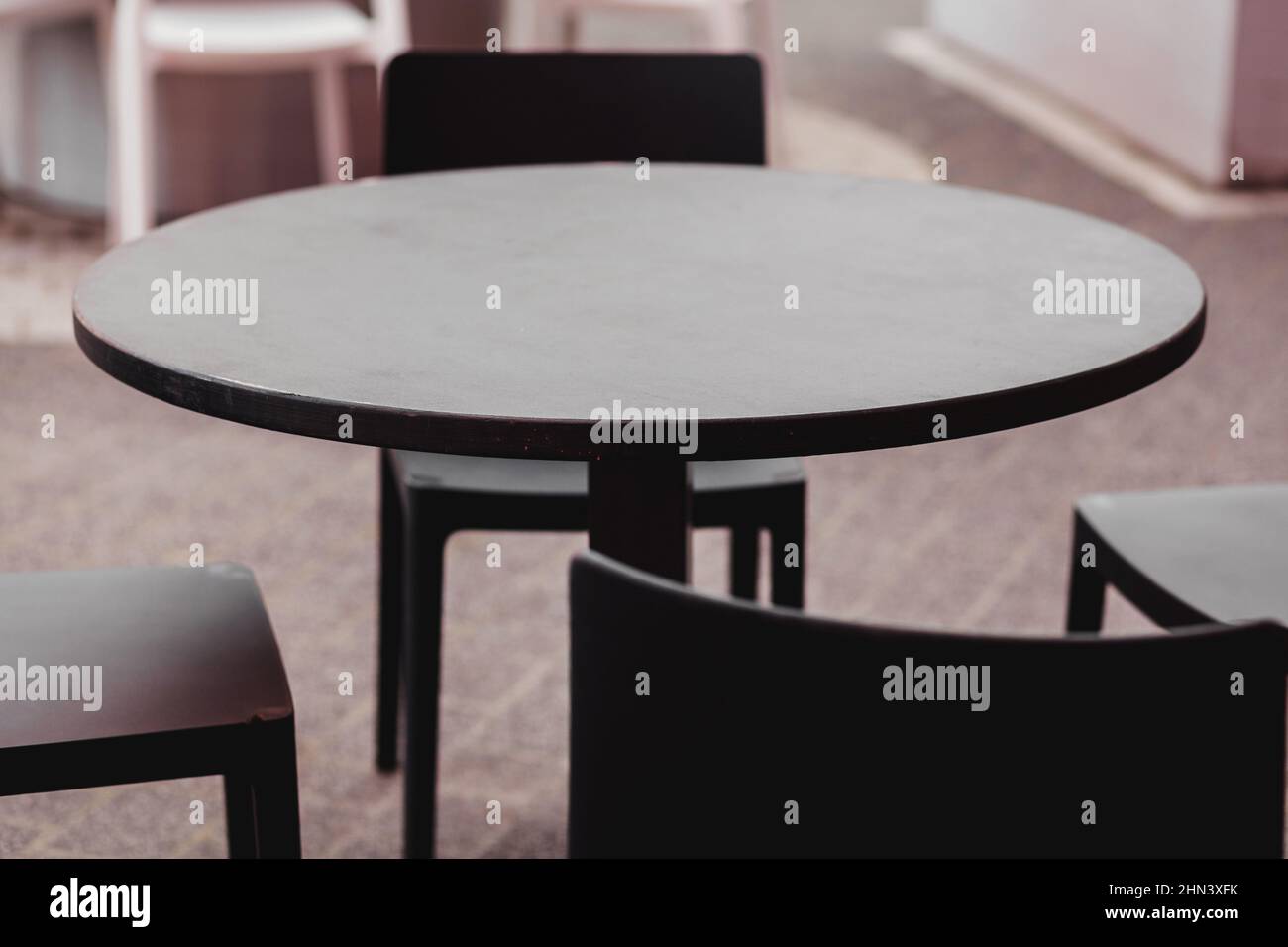 Round wooden table of street restaurant. empty outdoor cafe. no people ...