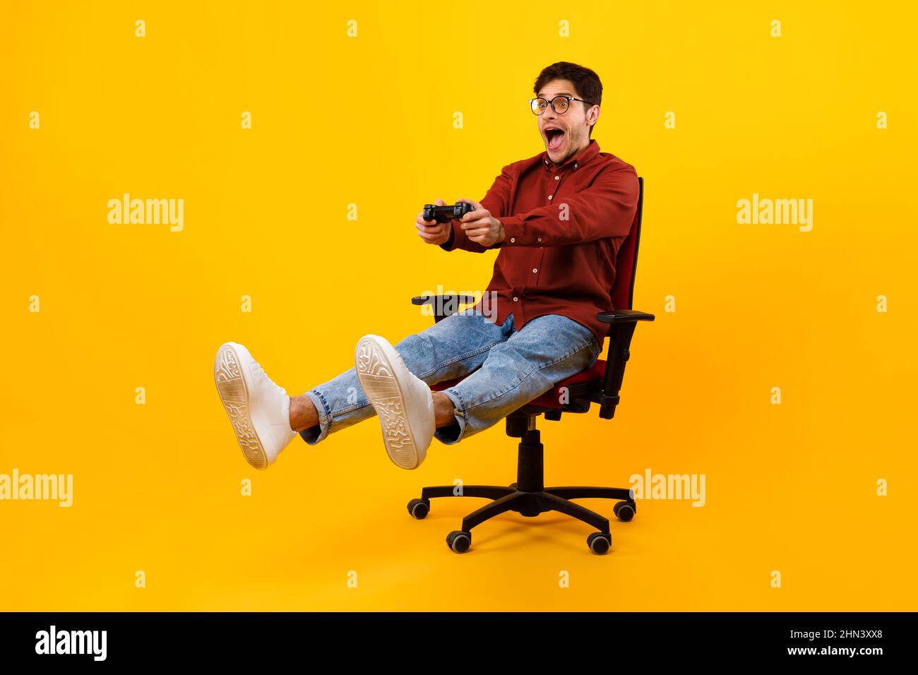 Young happy businessman playing game hi-res stock photography and ...