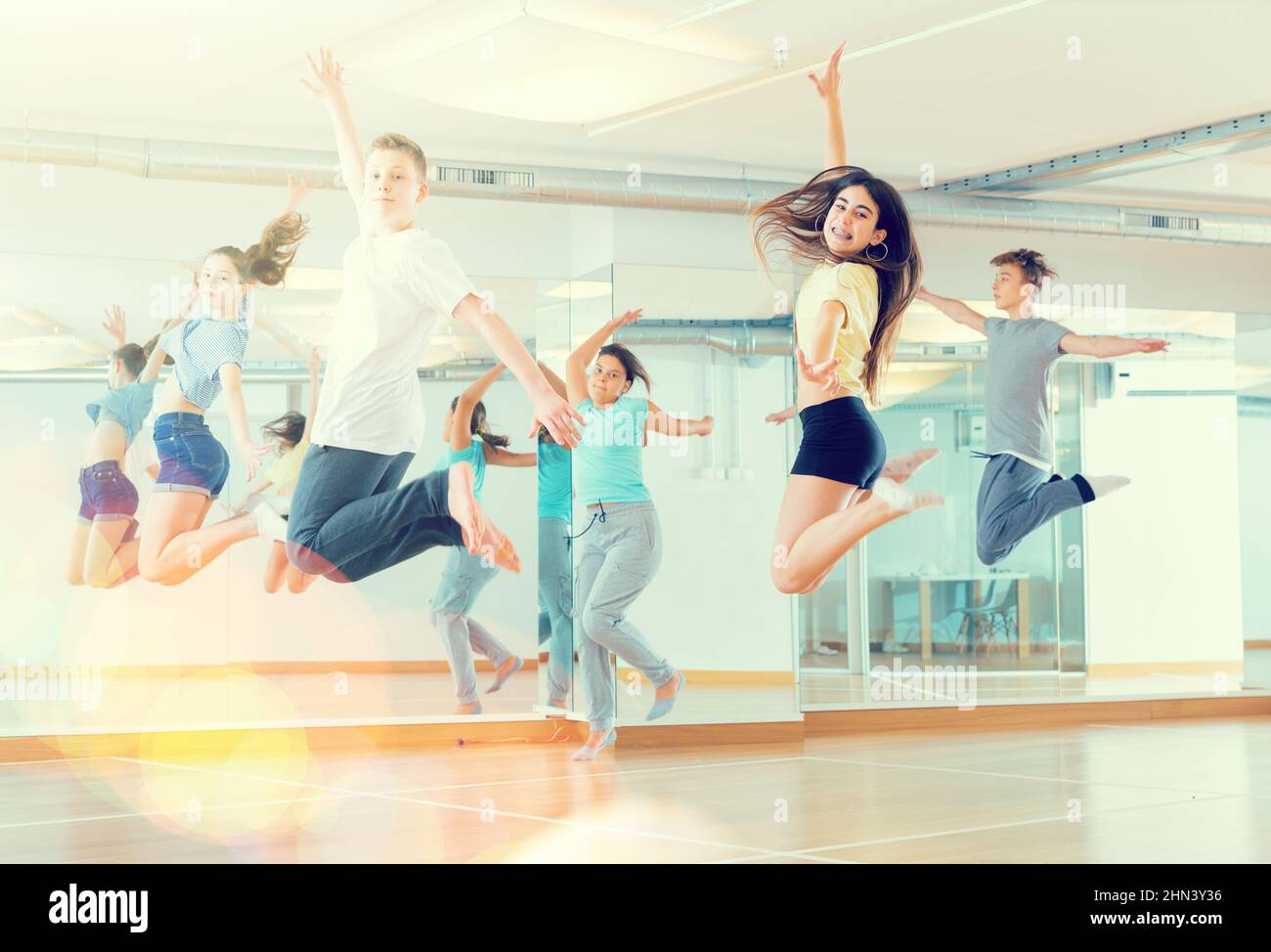 Group of teenagers jumping during dance workout Stock Photo - Alamy
