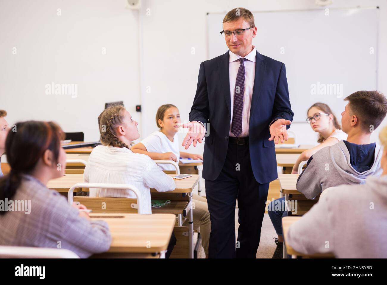 Male teacher lecturing to students at classroom Stock Photo - Alamy