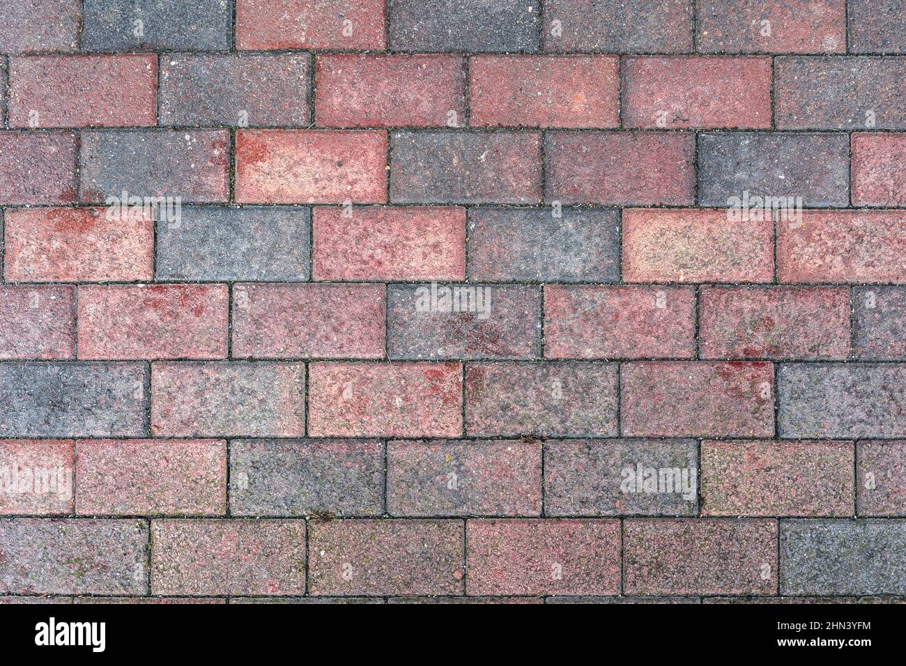 Red old stone pavement with abstract pattern closeup. crumble with age ...