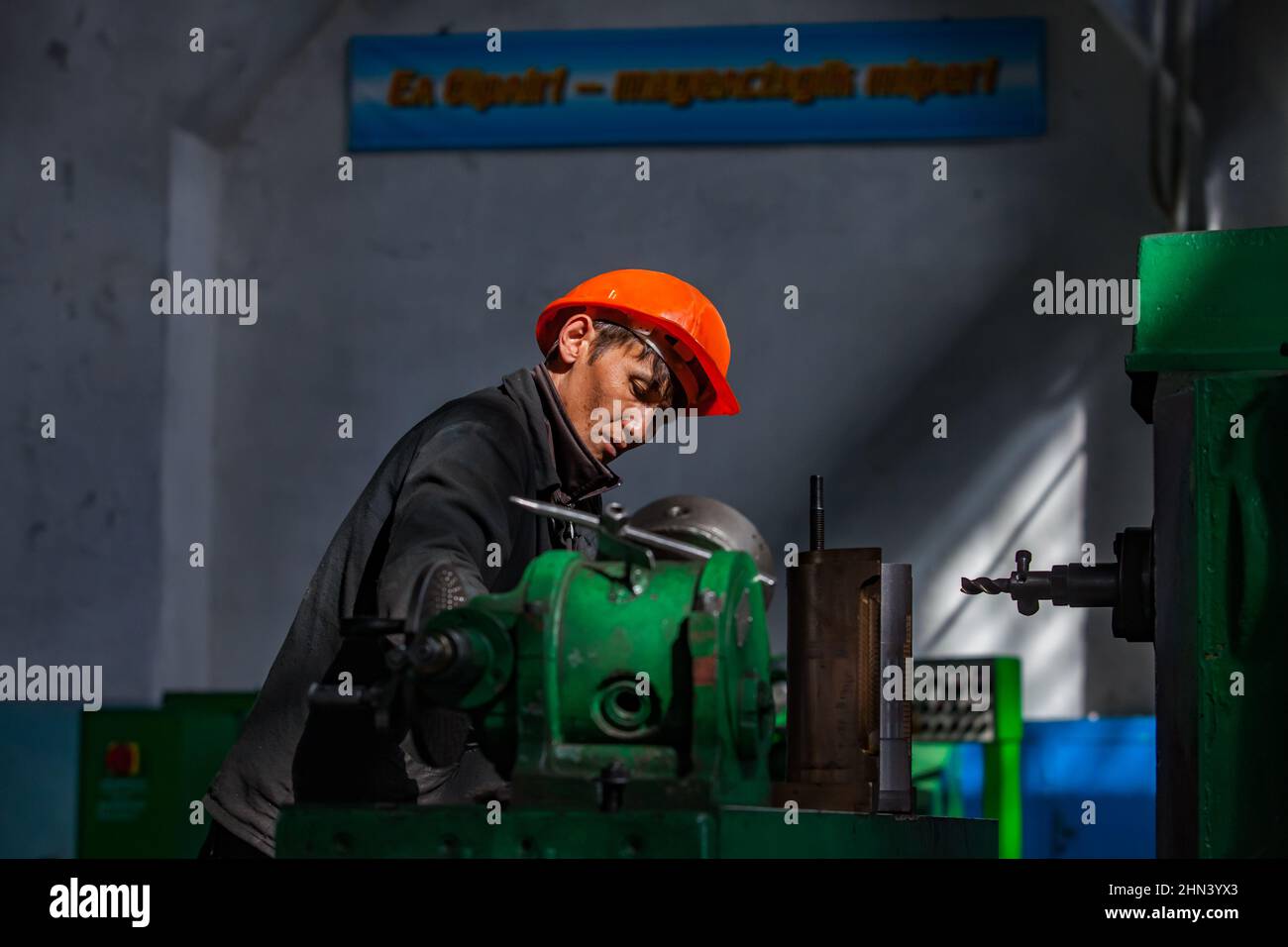 Kazaly, Kazakhstan - May 02, 2012: Young Asian turner operator works on ...