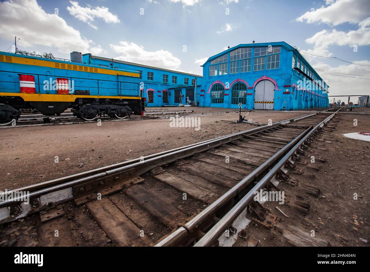 Vintage blue locomotive repair plant depot building. Blue Soviet loco ...