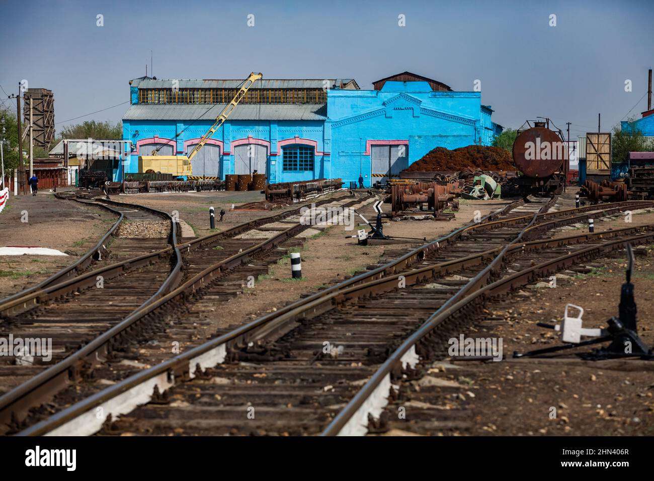 Vintage locomotive repair plant depot building. Railroad tracks with ...