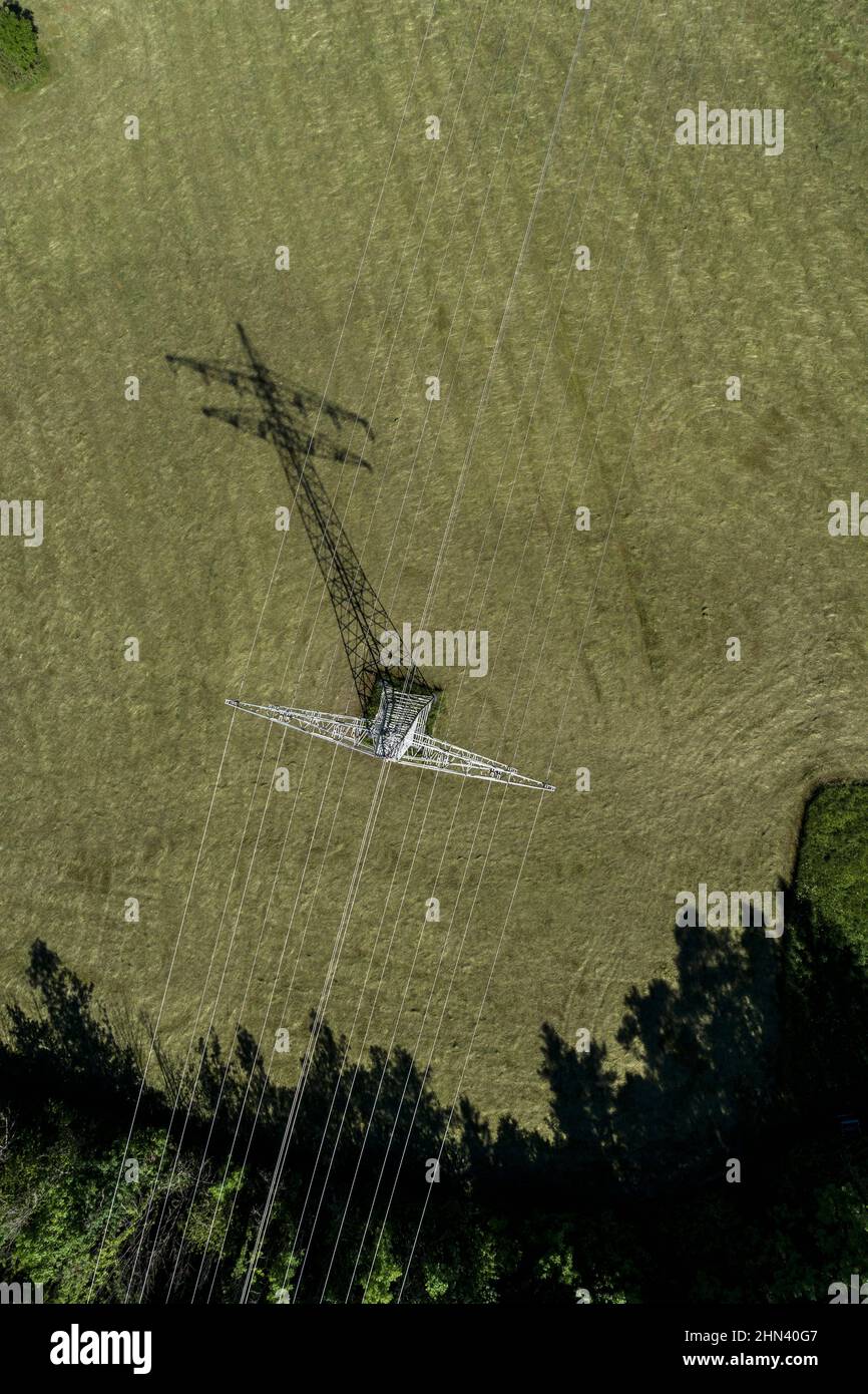 Aerial view electricity pylon over sunny green agricultural crop, Baden ...
