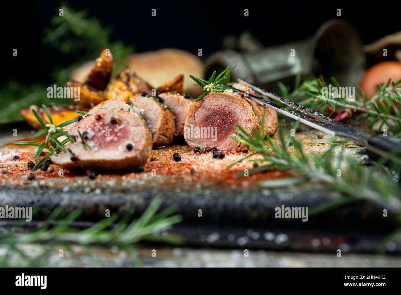 Pork tenderloin chops served with potatoes and rosemary in the kitchen ...