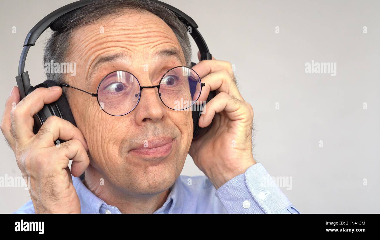 Happy older man listening to music Stock Photo - Alamy