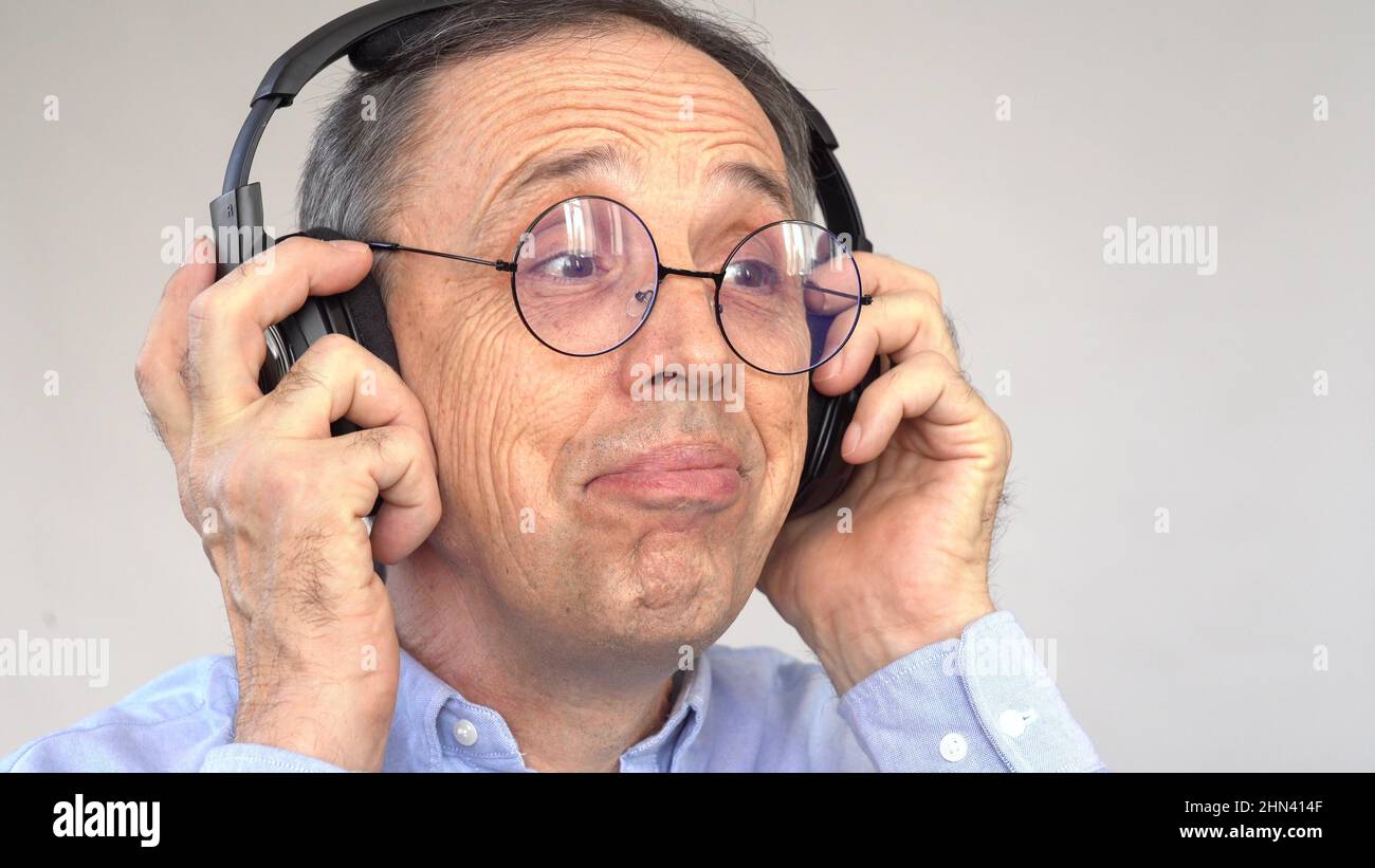 Happy older man listening to music Stock Photo - Alamy