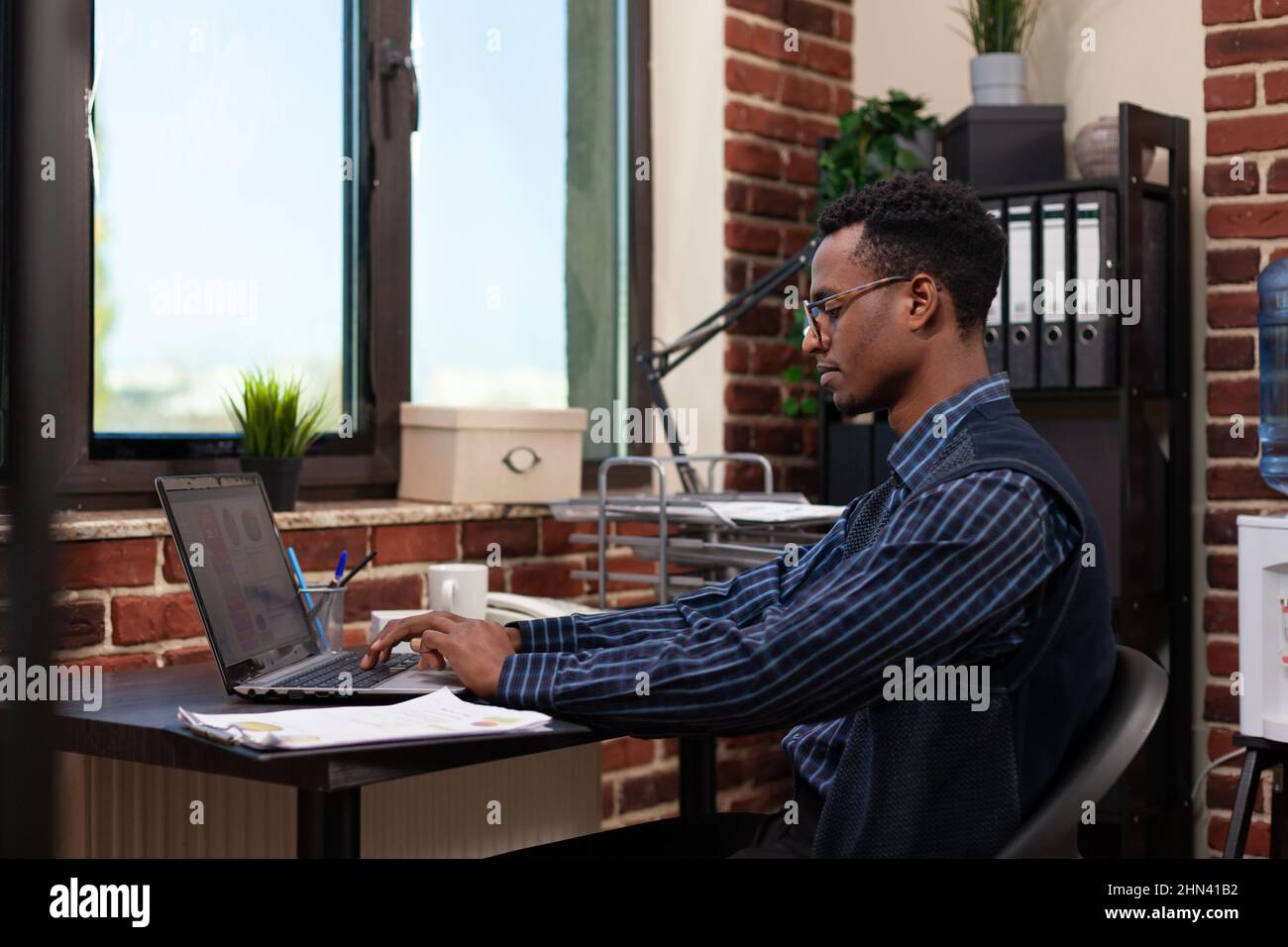 Office startup employee typing on laptop working on business sales ...