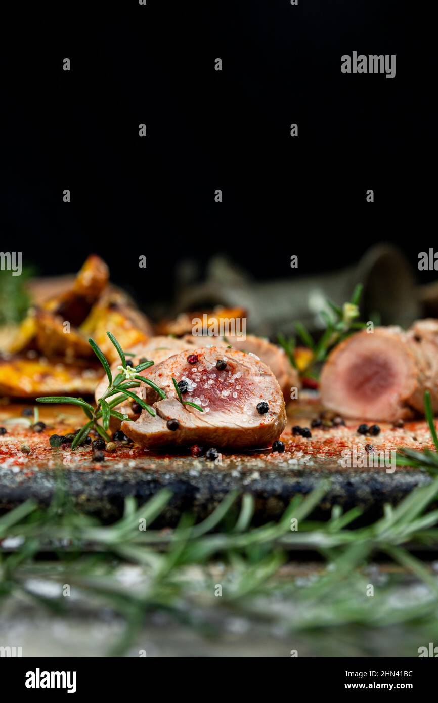Pork tenderloin chops served with potatoes and rosemary in the kitchen ...