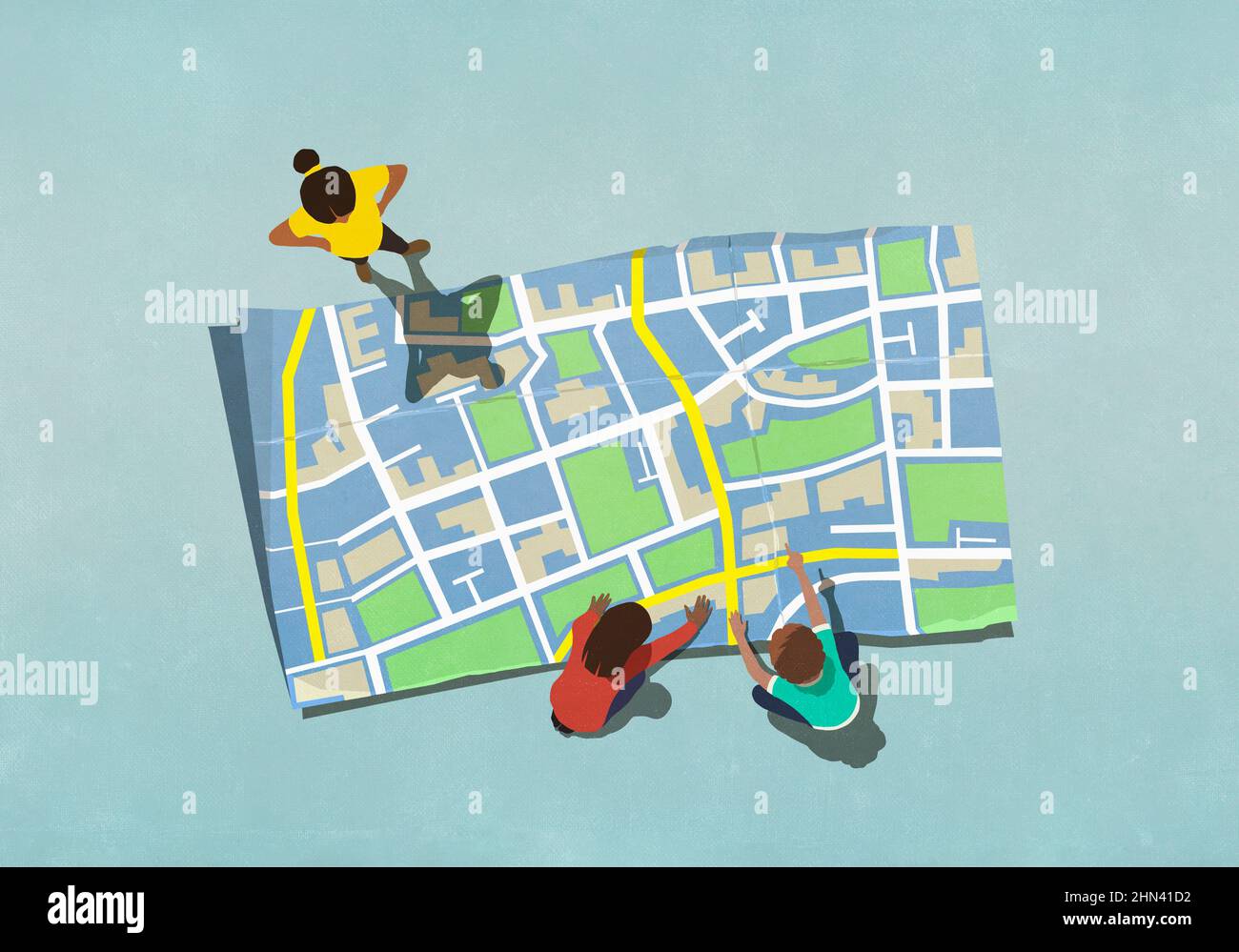 View from above kids looking at large map Stock Photo - Alamy