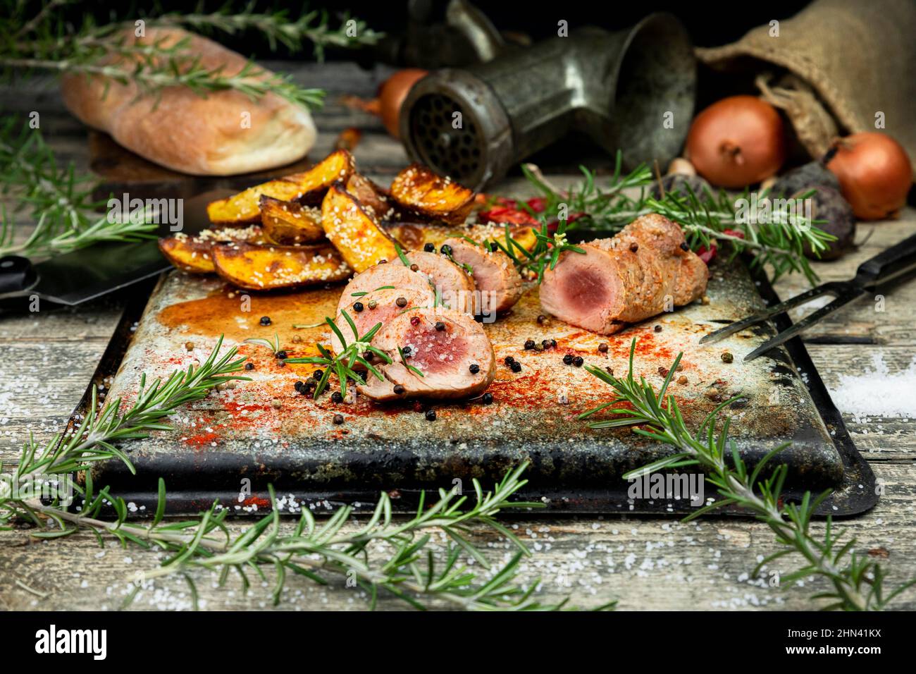 Pork tenderloin chops served with potatoes and rosemary in the kitchen ...