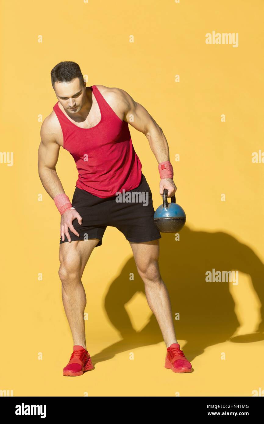 Lifting kettlebell man in red hi-res stock photography and images - Alamy