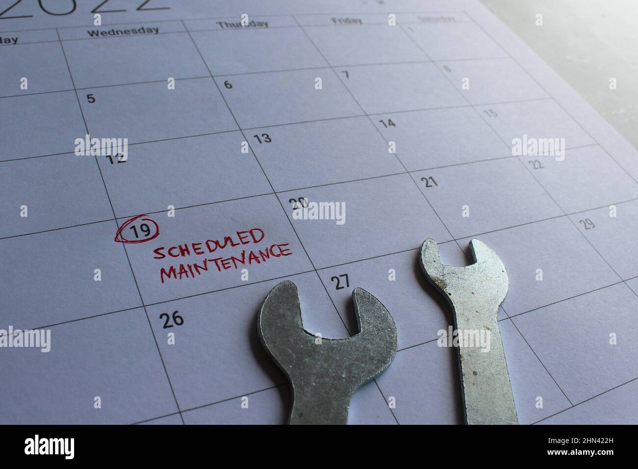 Scheduled maintenance concept. Spanner and calendar with text SCHEDULED ...