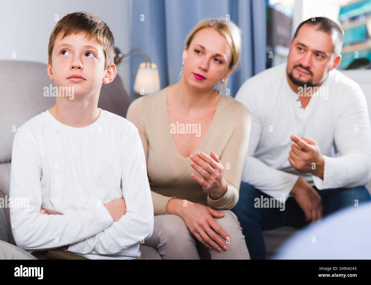 Parents berating frustrated boy Stock Photo - Alamy