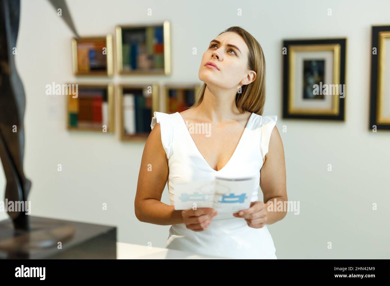 Woman observing museum exposition Stock Photo - Alamy