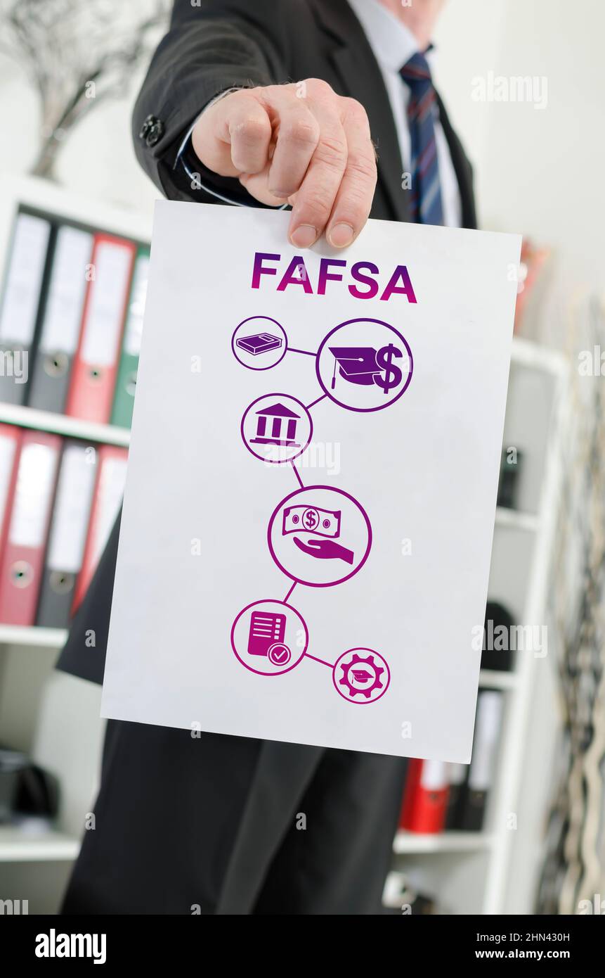 Paper showing fafsa concept held by a businessman Stock Photo - Alamy
