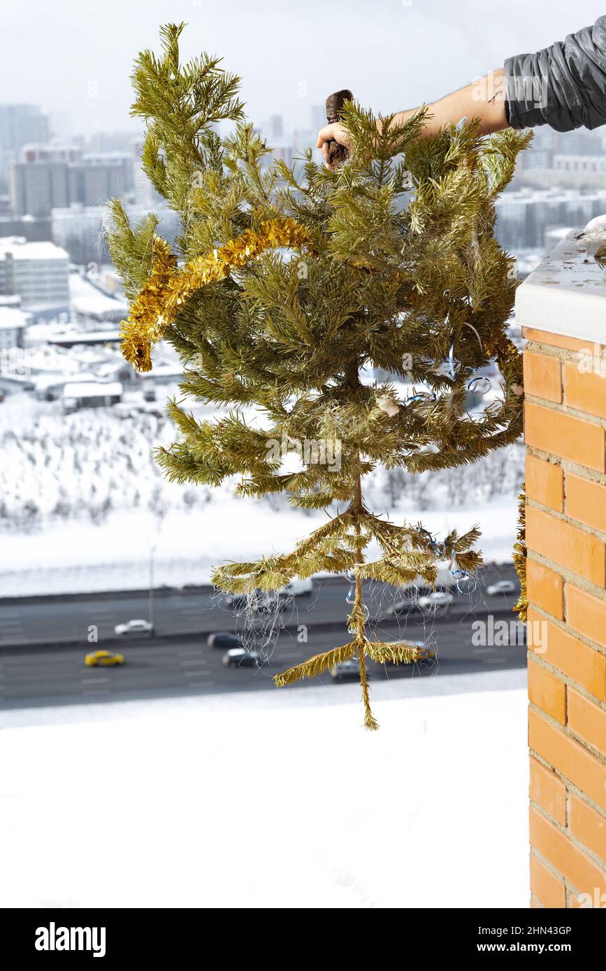 Concept the ending of holidays and celebrations. Man throwing away ...