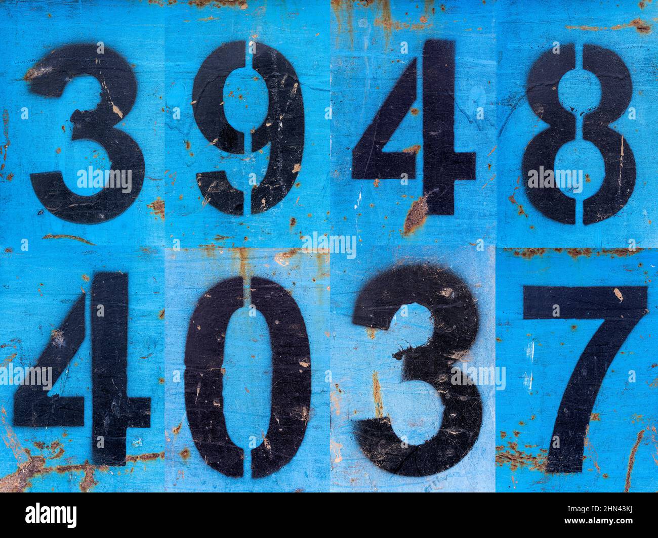 Numbers in black paint on an old blue iron surface with rust texture ...