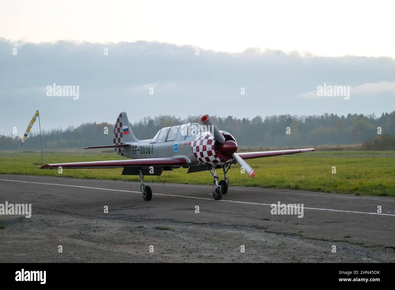 Plane preparing to take off in cloudy evening Stock Photo - Alamy